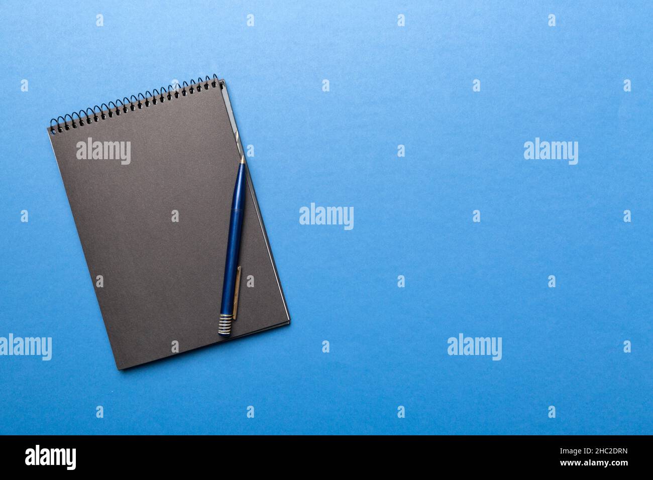 school notebook on a colored background, spiral black notepad on a ...