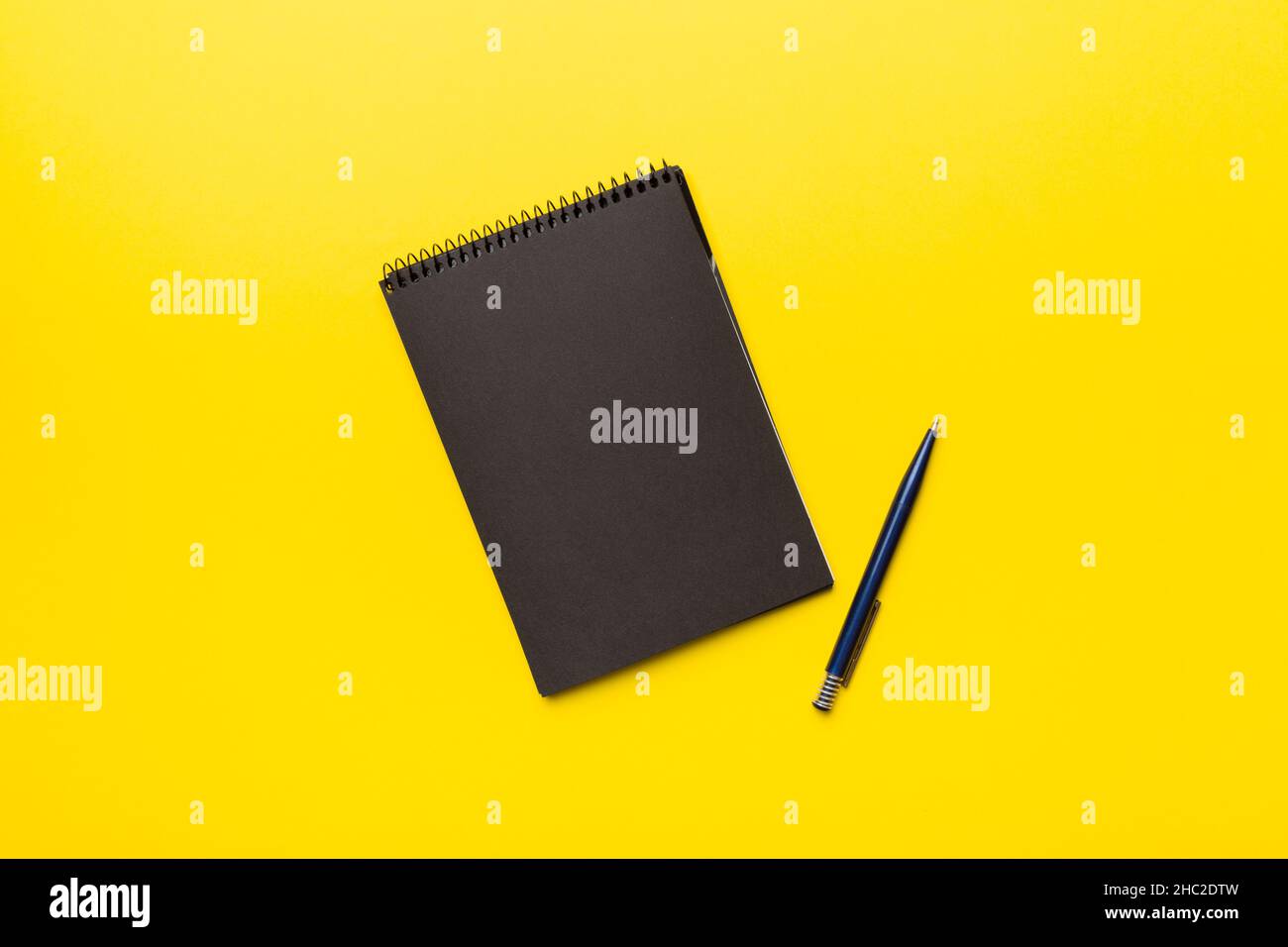 school notebook on a colored background, spiral black notepad on a ...