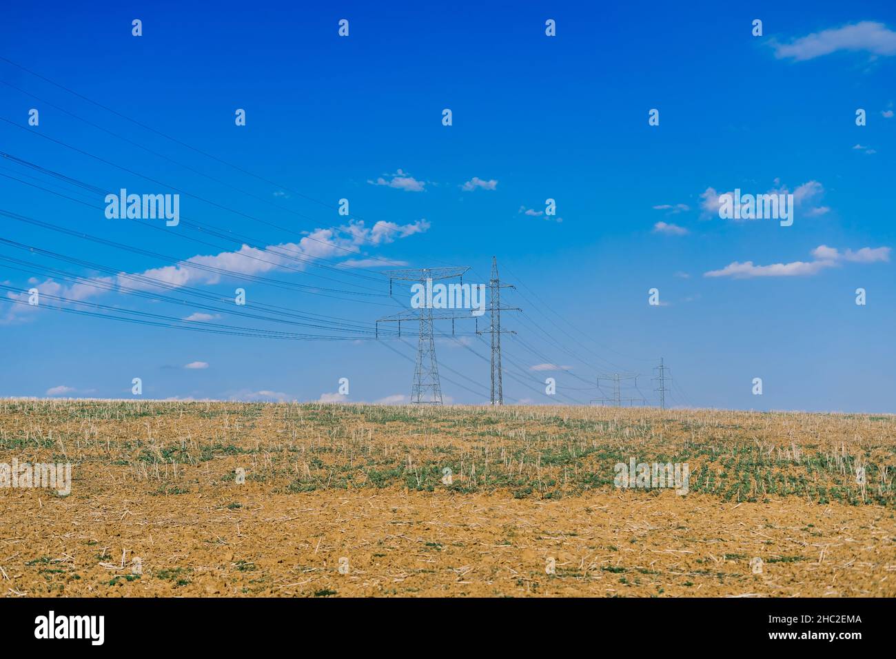 Electric power transmission lines at sky background, an autumn field ...