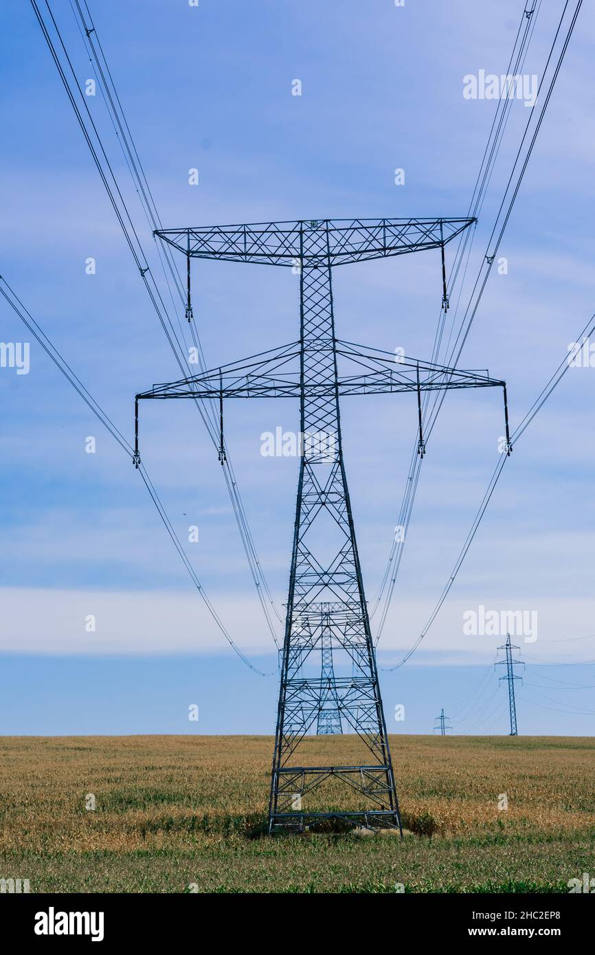 Electric power transmission lines at sky background, an autumn field ...