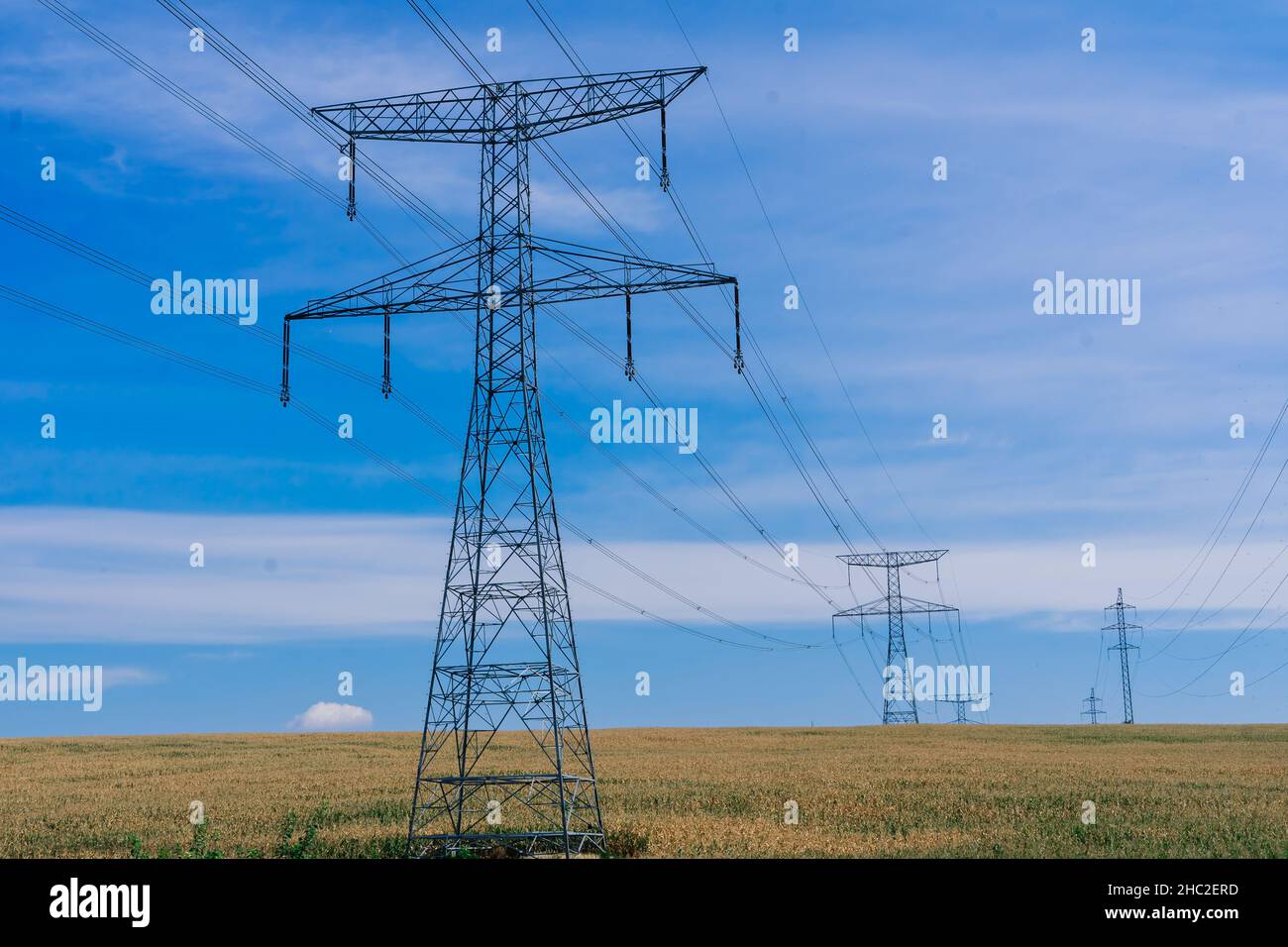 Electric power transmission lines at sky background, an autumn field ...