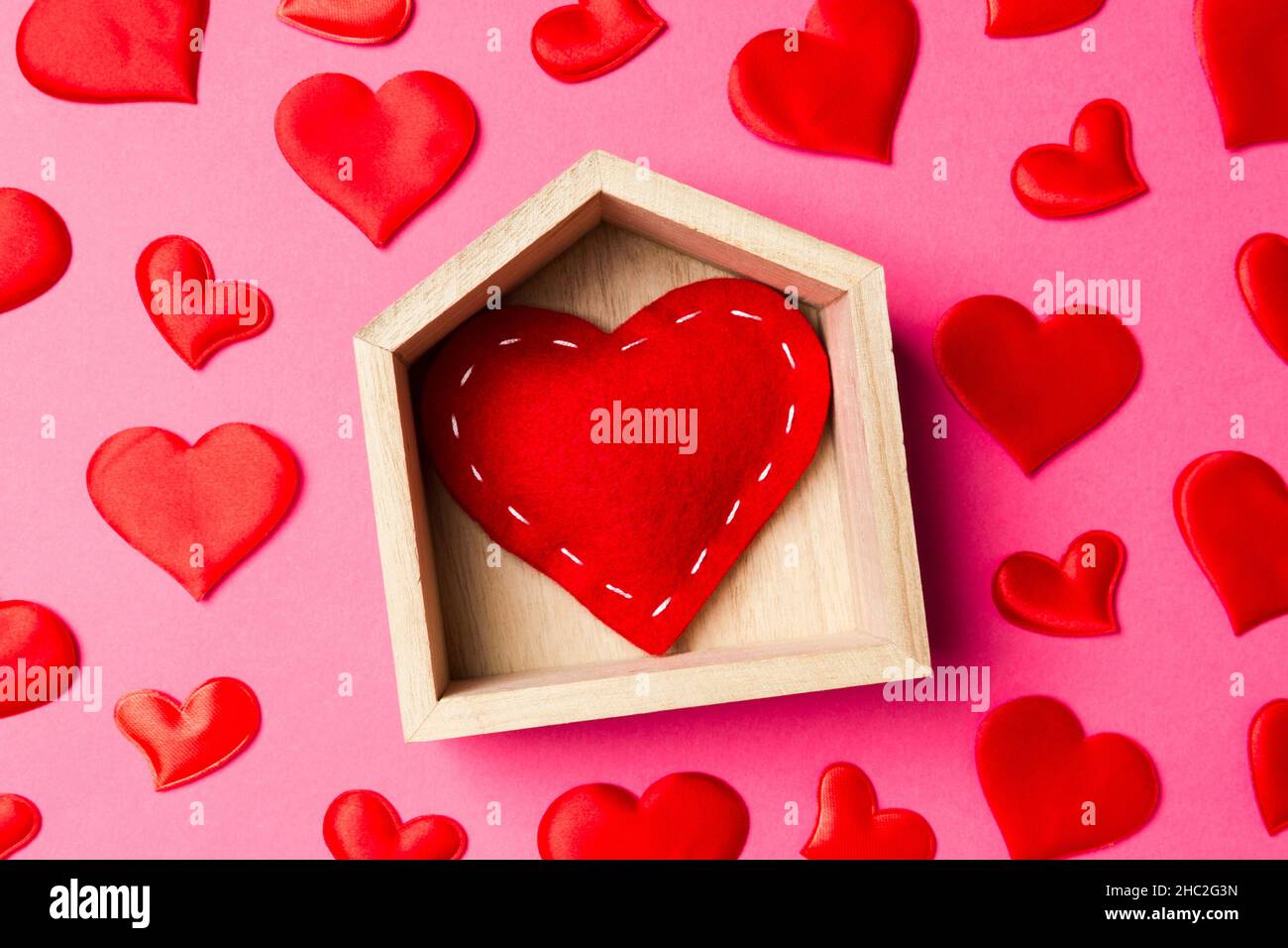 Close up of red heart in a wooden house decorated with small hearts on ...