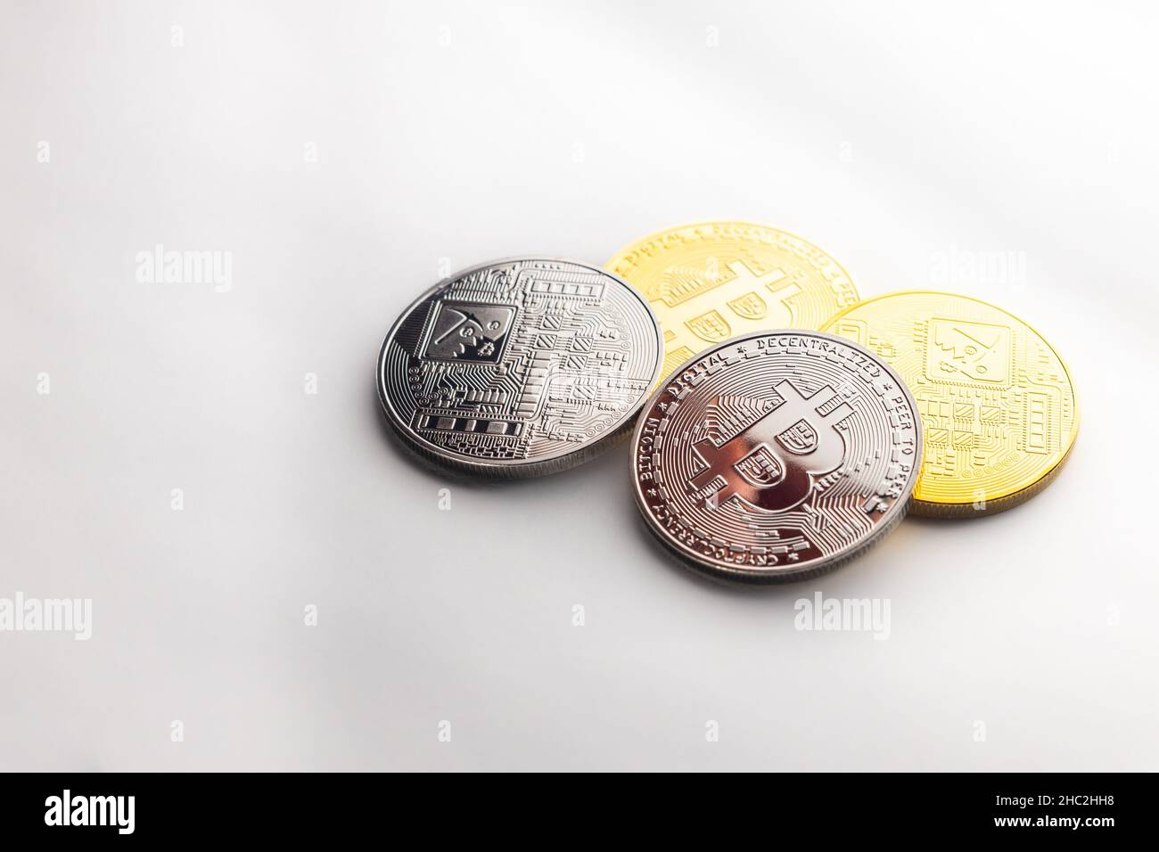 Multiple crypto Bitcoin gold and silver coins photographed on a white ...