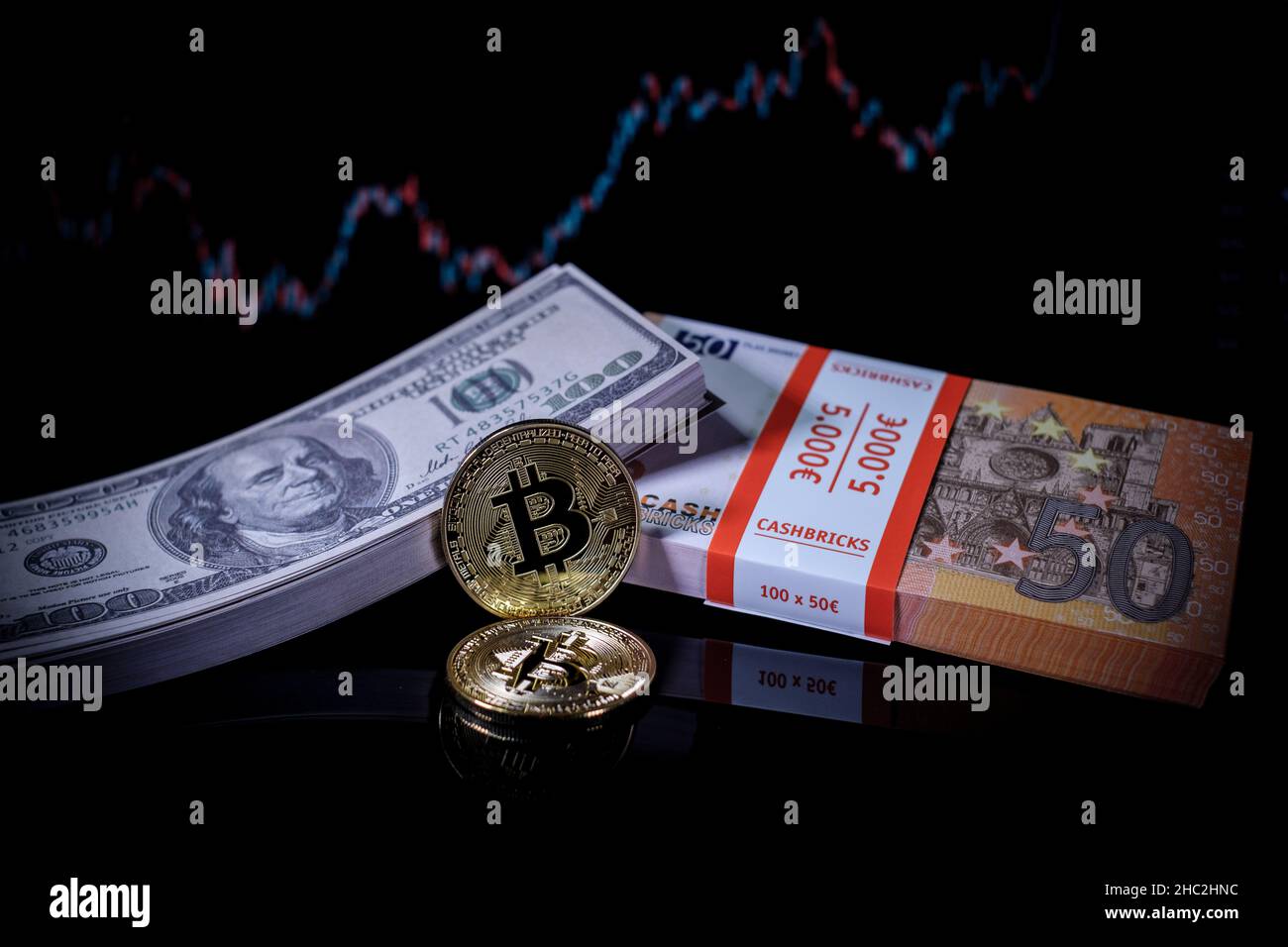 one bitcoin coin lies next to a stack of dollar notes and a stack of ...