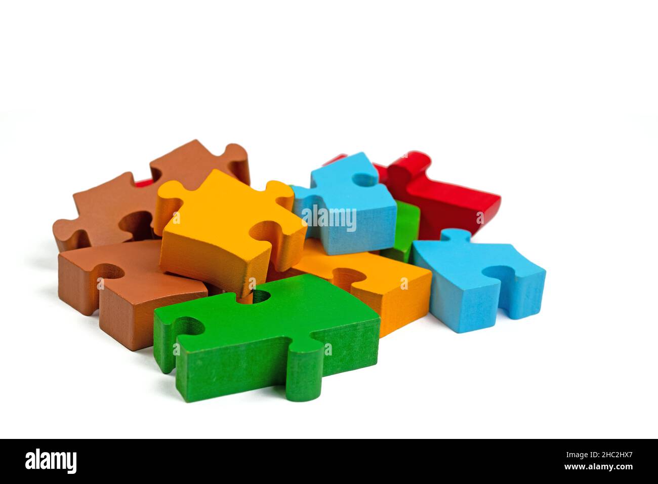 Colorful wooden puzzle pieces against white background Stock Photo - Alamy