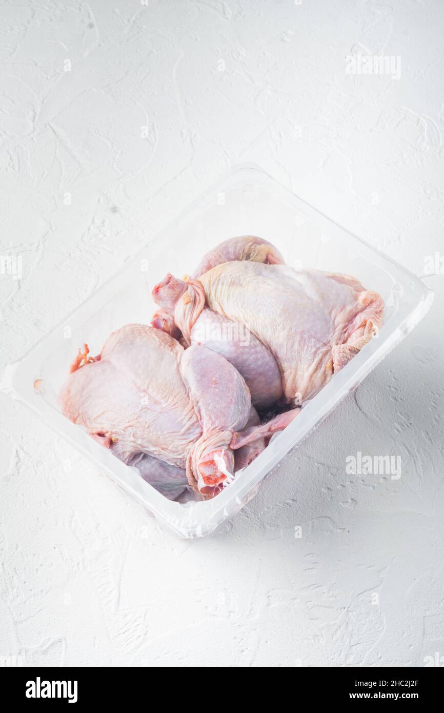 Raw chicken in plastic sealed plastic box, on white background with ...