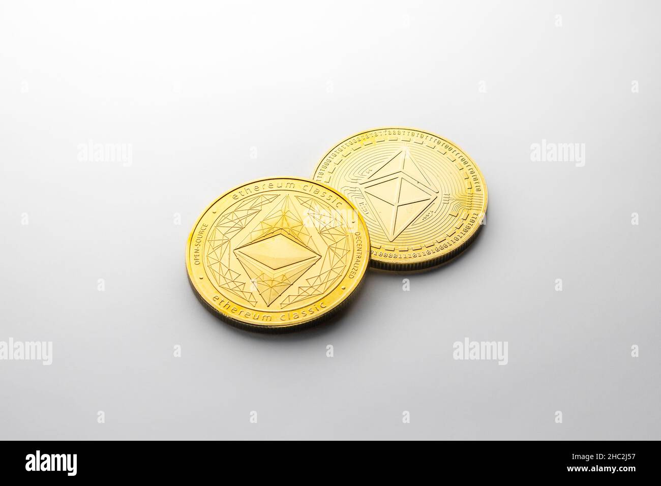 Multiple crypt gold Ethereum coins photographed on a white background ...