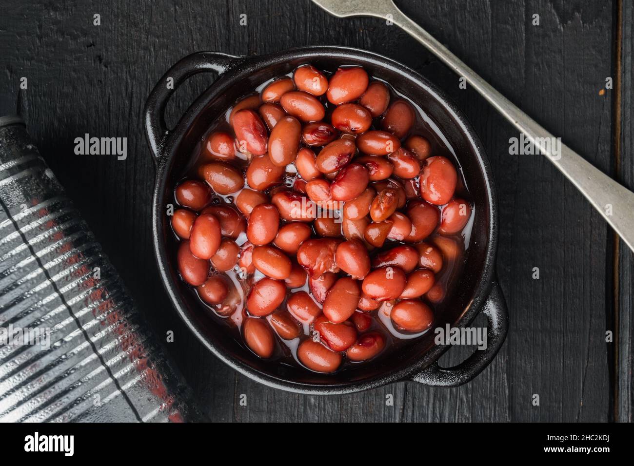 Japanese canned food ingredient, sweet red beans, on black wooden table ...