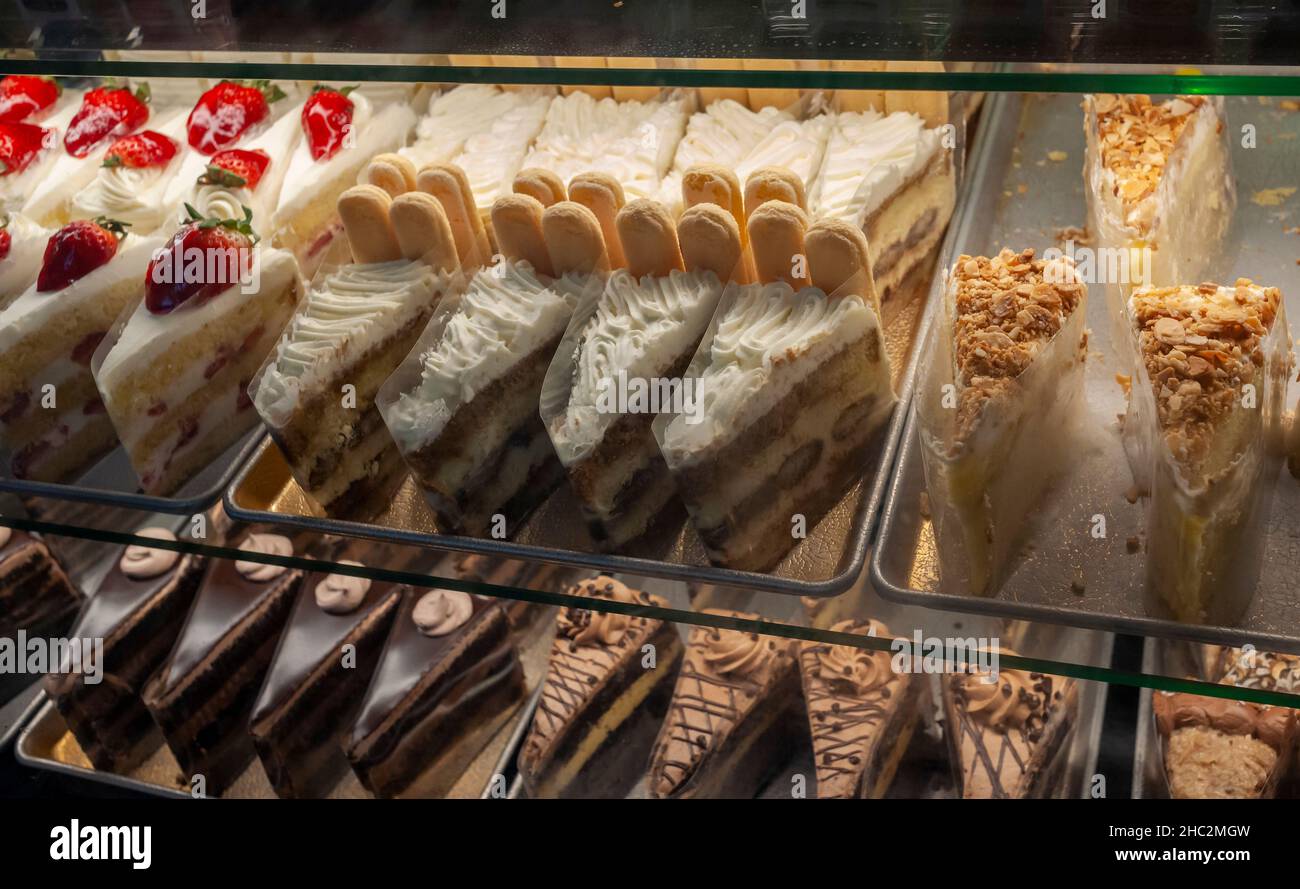 A display of various cakes and other baked goods in a bakery in New ...