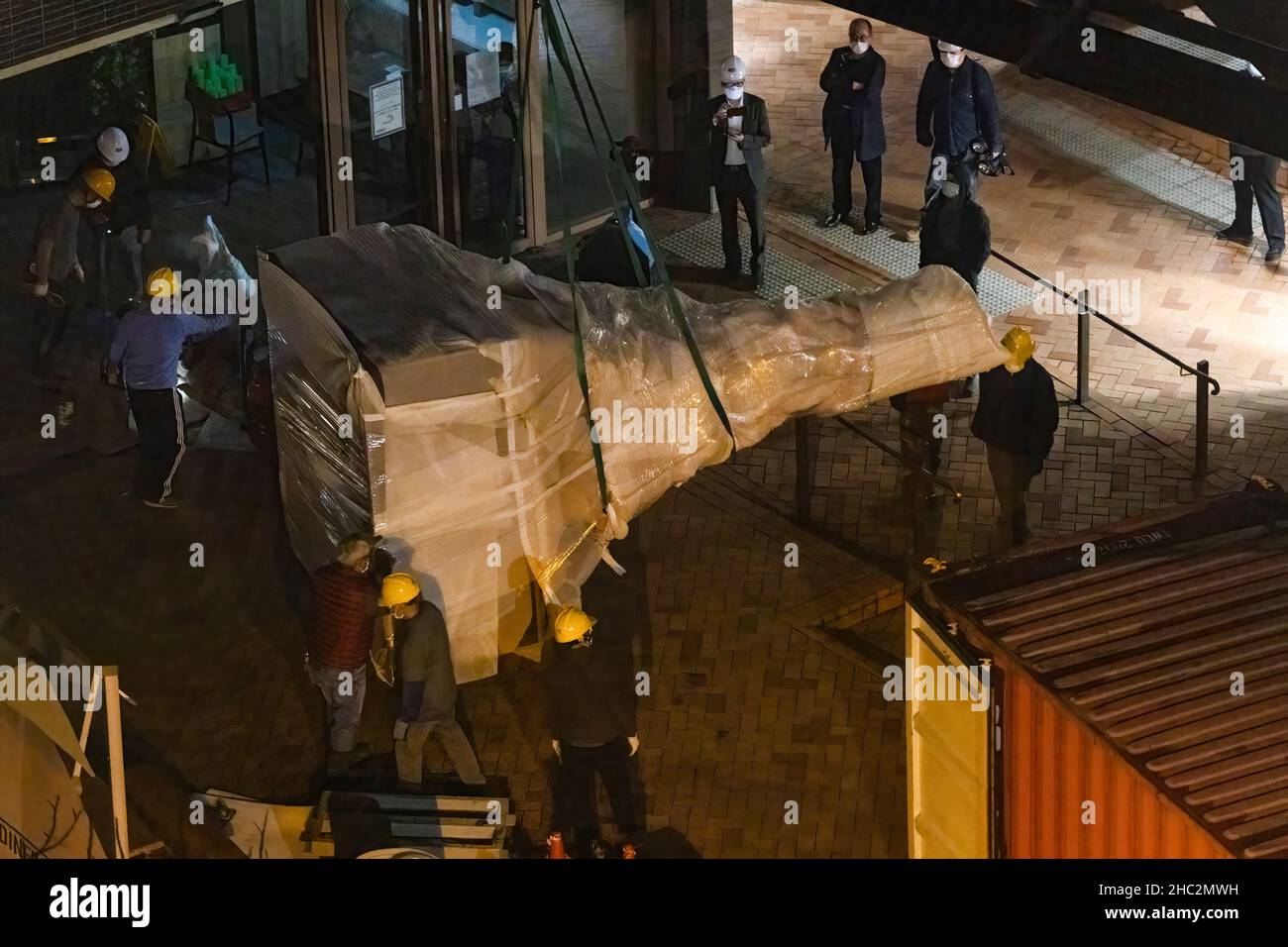 The lower-half of the statue was hanged by the crane and ready to be ...