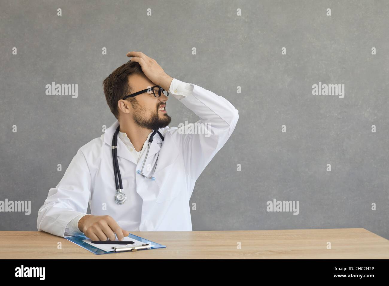 Adult disappointed overworked doctor feeling shame and stress with hand ...