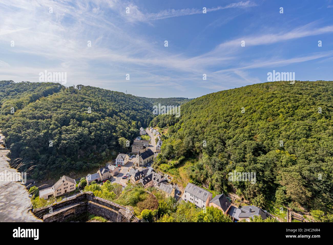 Countryside with mountains covered with green leafy trees, country road ...