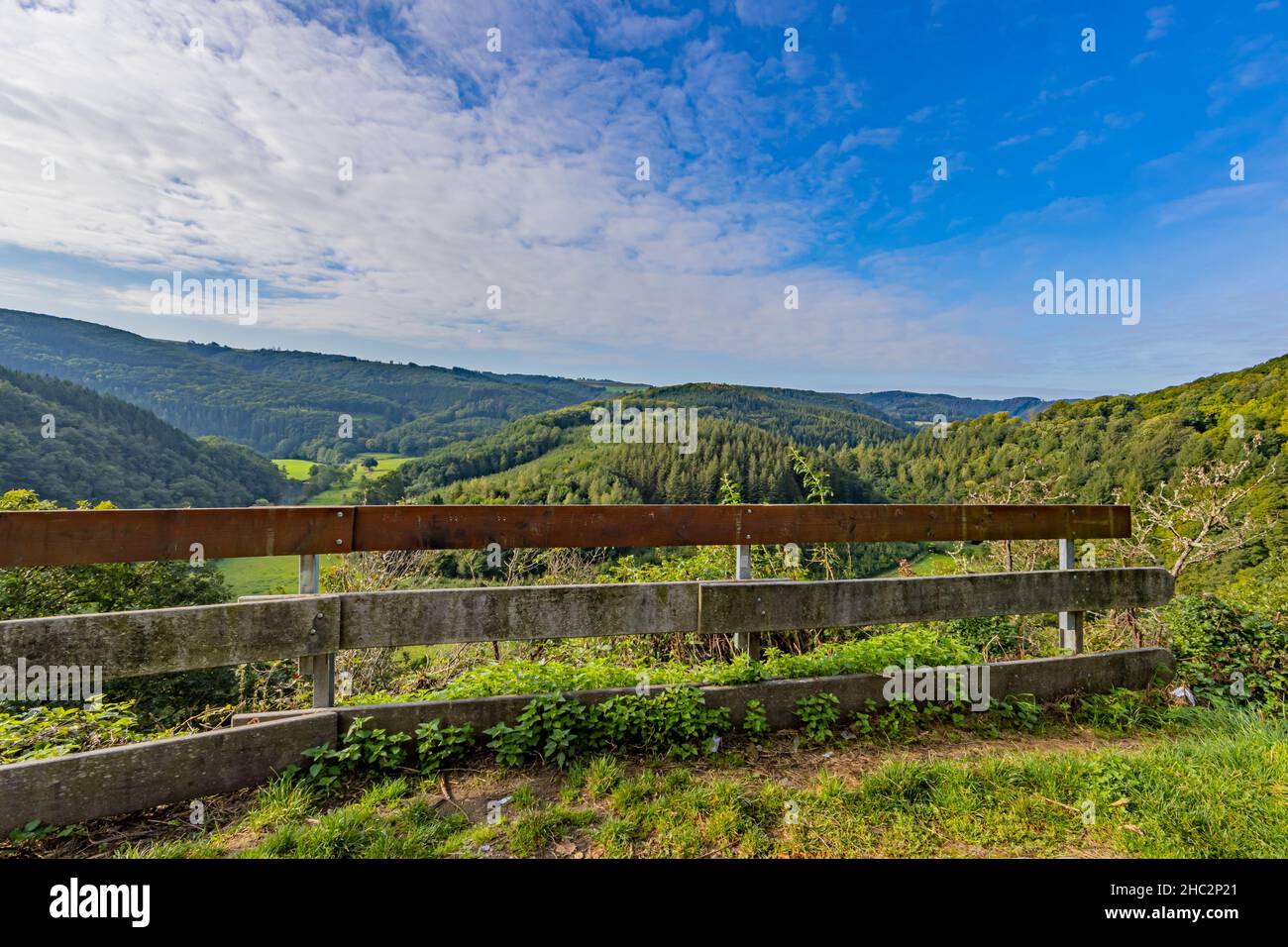Viewpoint with a wooden fence, valley landscape with mountains and ...