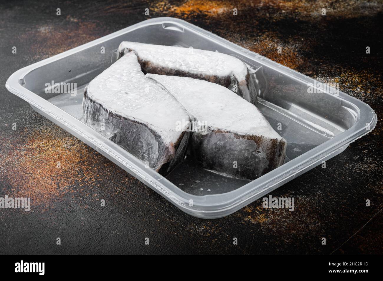 Halibut iced fillet plastic pack set, on old dark rustic table ...