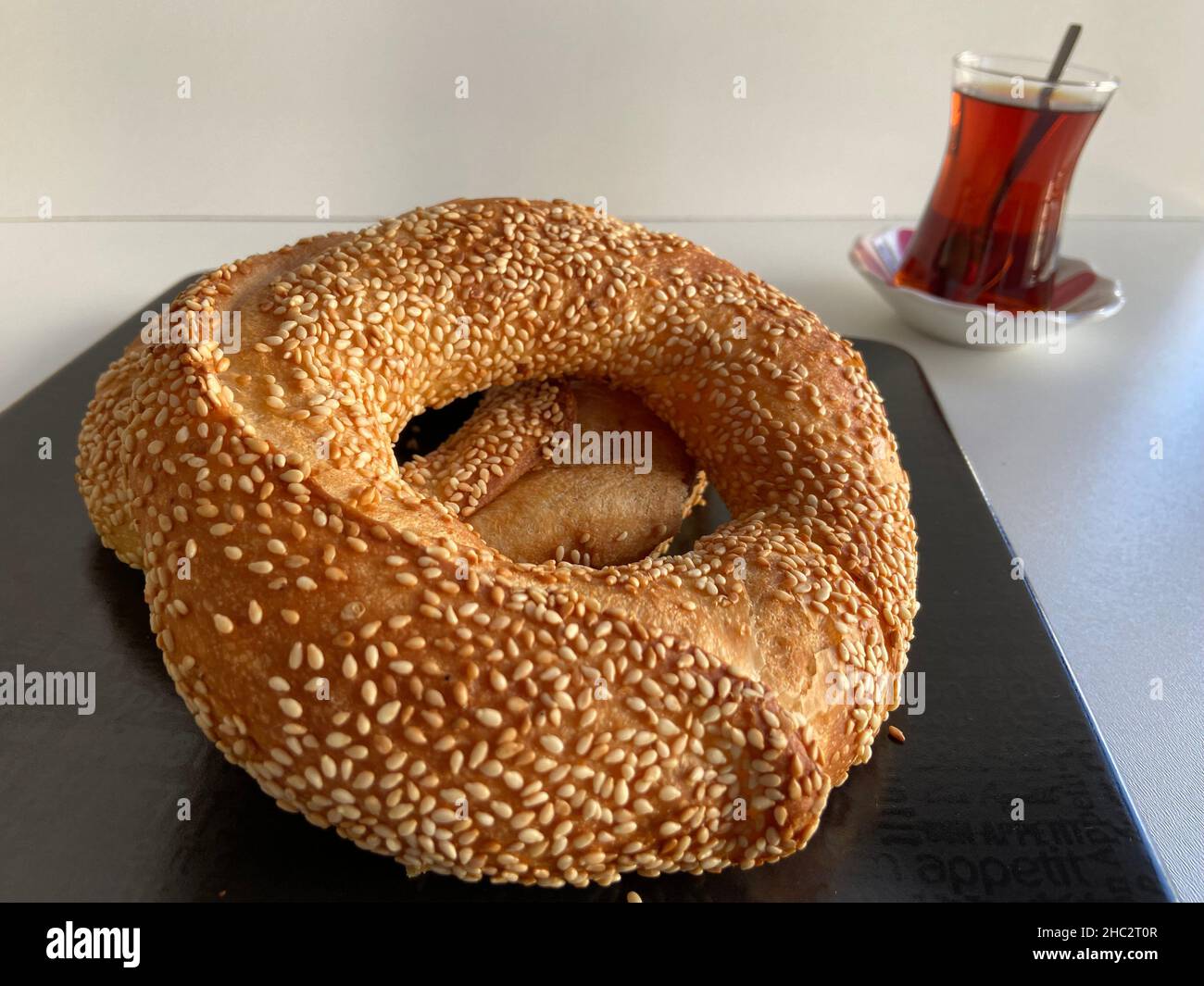 Simit or gevrek, traditional Turkish street food with tea. Breakfast ...