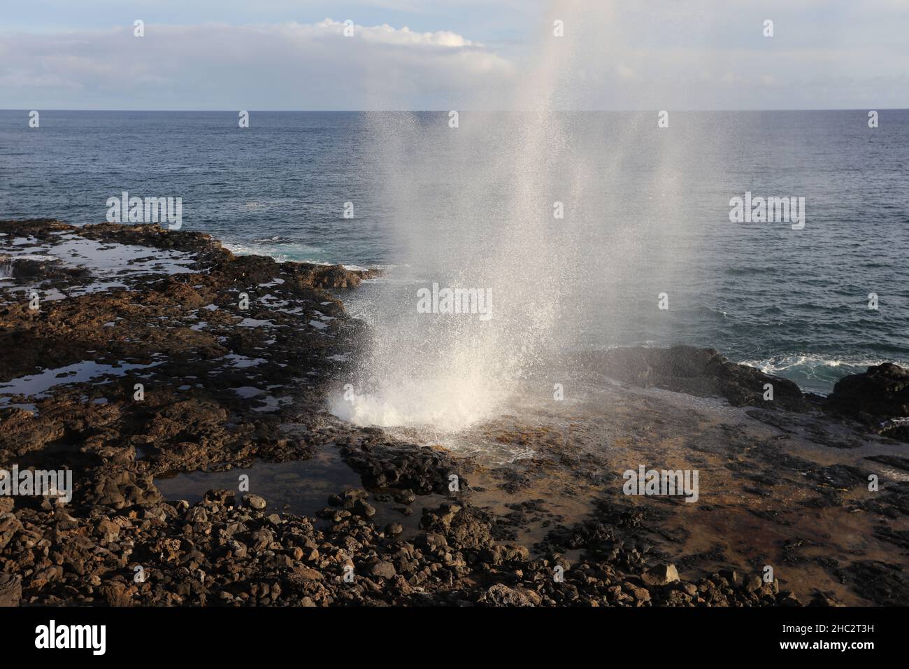 The Spouting Horn blowhole erupting with water spraying 15 feet into ...