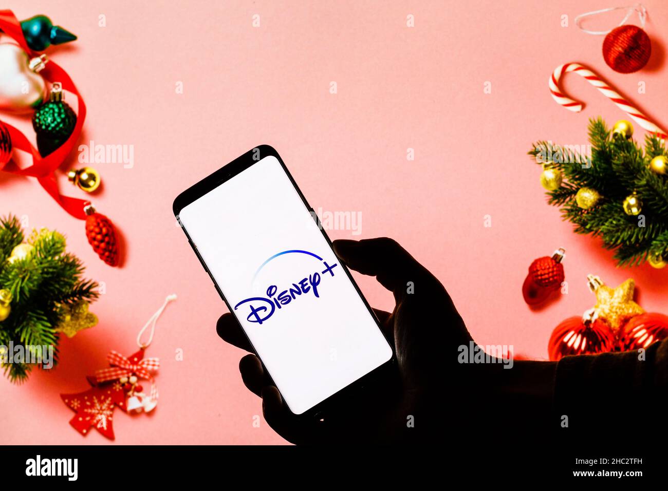 In this photo illustration a Disney Plus logo seen displayed on a ...
