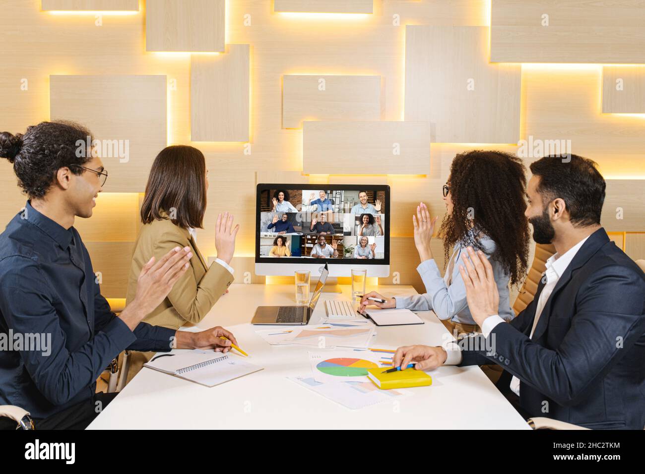 Multi ethnic group of business people having discussion with another ...