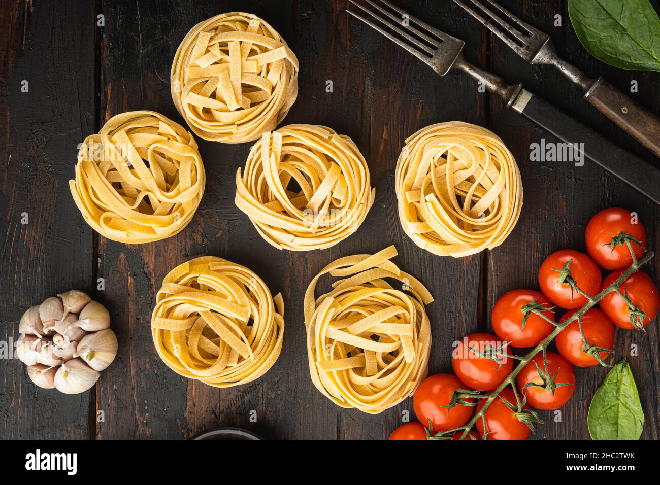 Raw tagliatelle nests Traditional Italian pasta set, top view flat lay ...