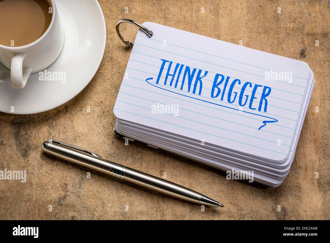 think bigger motivational reminder or advice - handwriting on an index ...