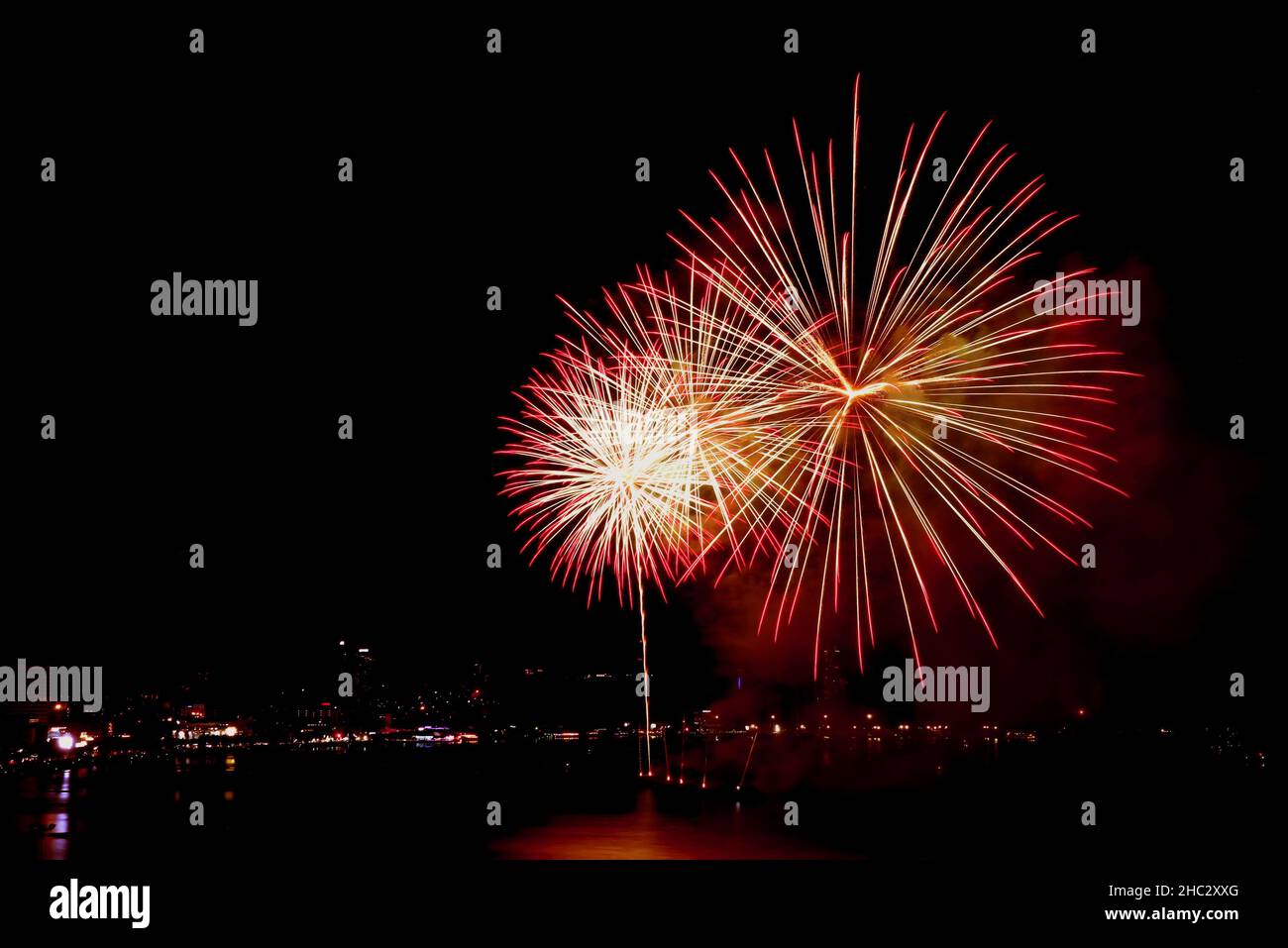 Spectacular red and gold fireworks exploding in to the night sky over ...