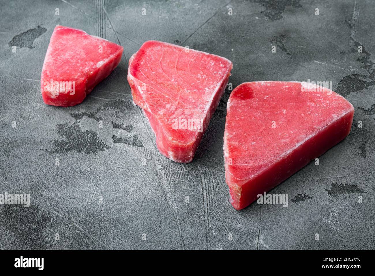 Raw frozen tuna fish fillet set, on gray stone background Stock Photo ...