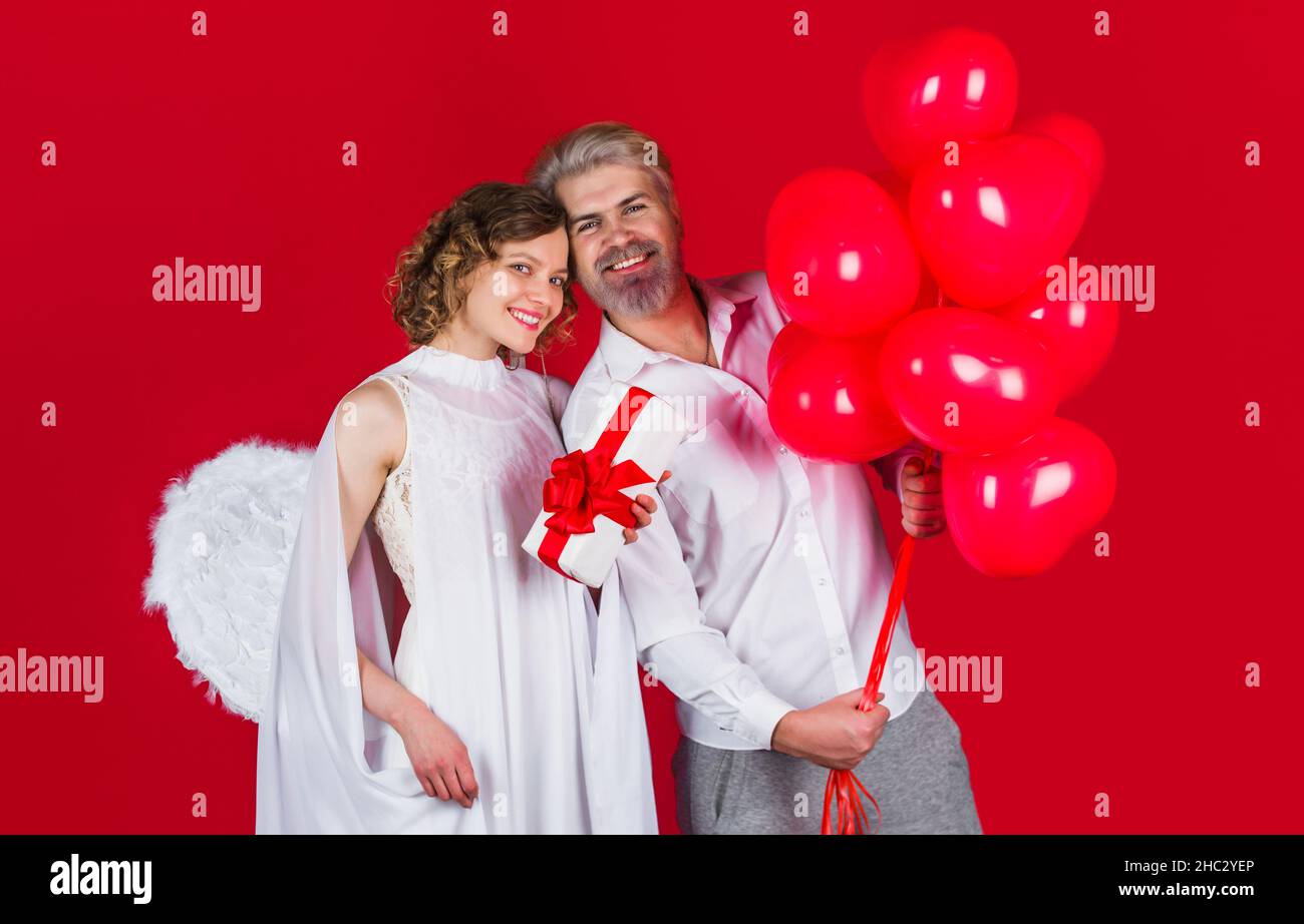 Valentines Day celebration. Happy Angels with gift and heart shape ...