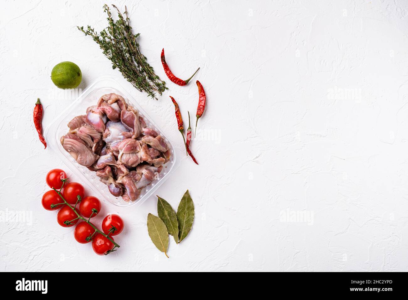 Raw uncooked chicken gizzards, stomach in plastic pack set, on white ...