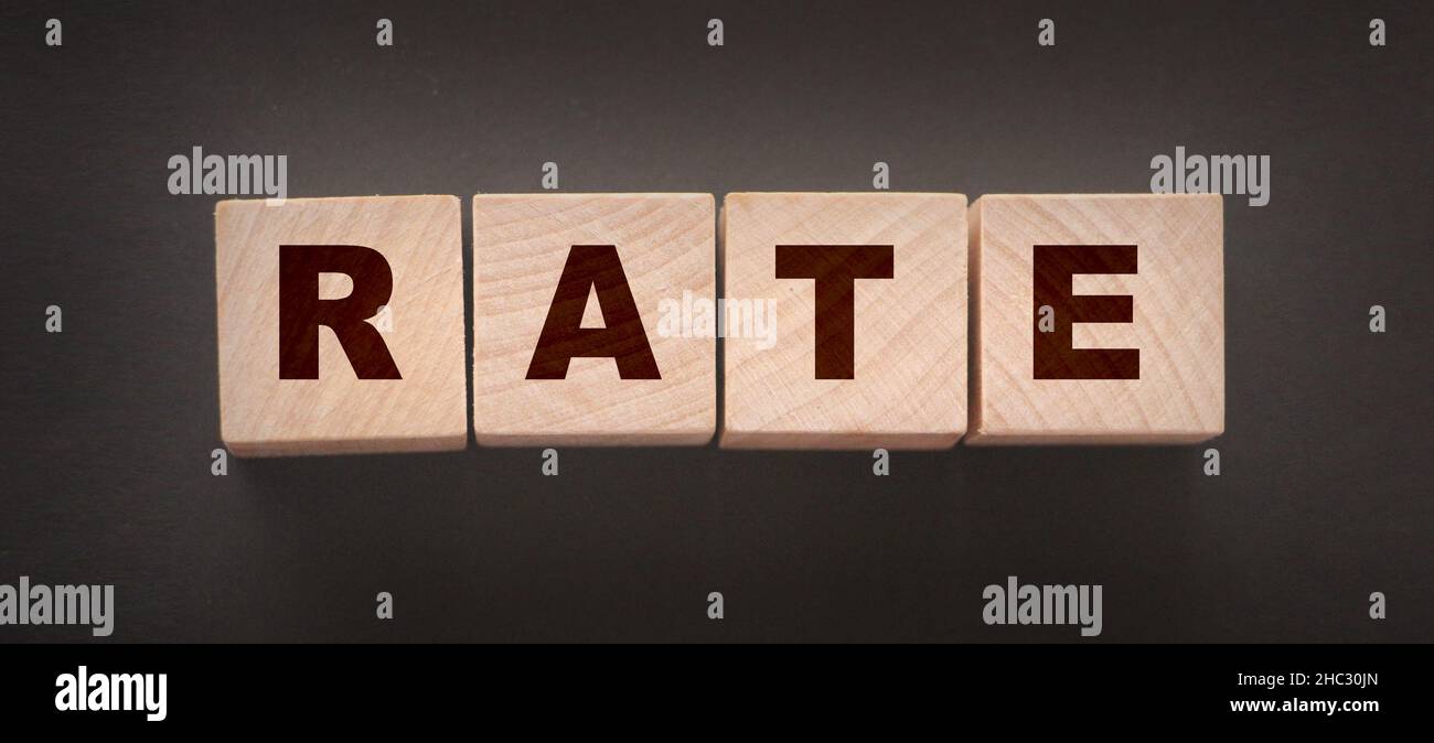 Rate word concept written on wooden cubes blocks lying on a black ...
