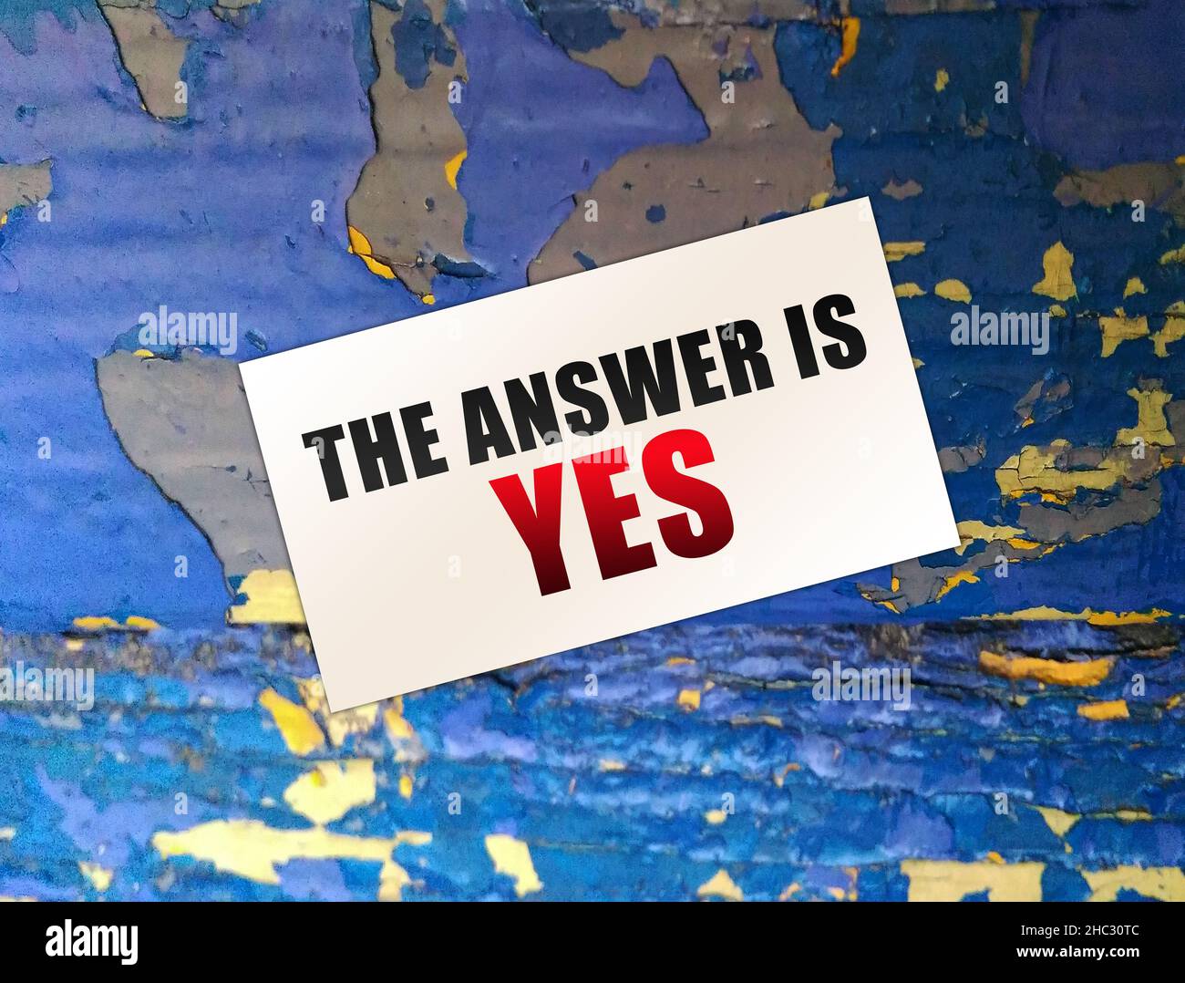 the words Answer is Yes on the card on wooden table. Positive solution ...