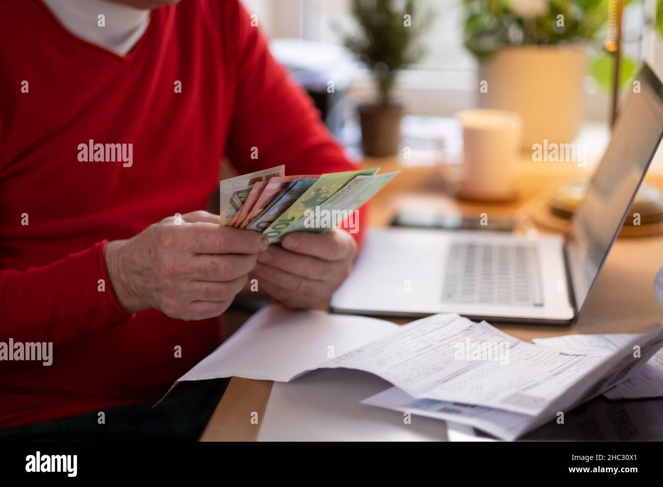 Senior man counting money table hi-res stock photography and images - Alamy
