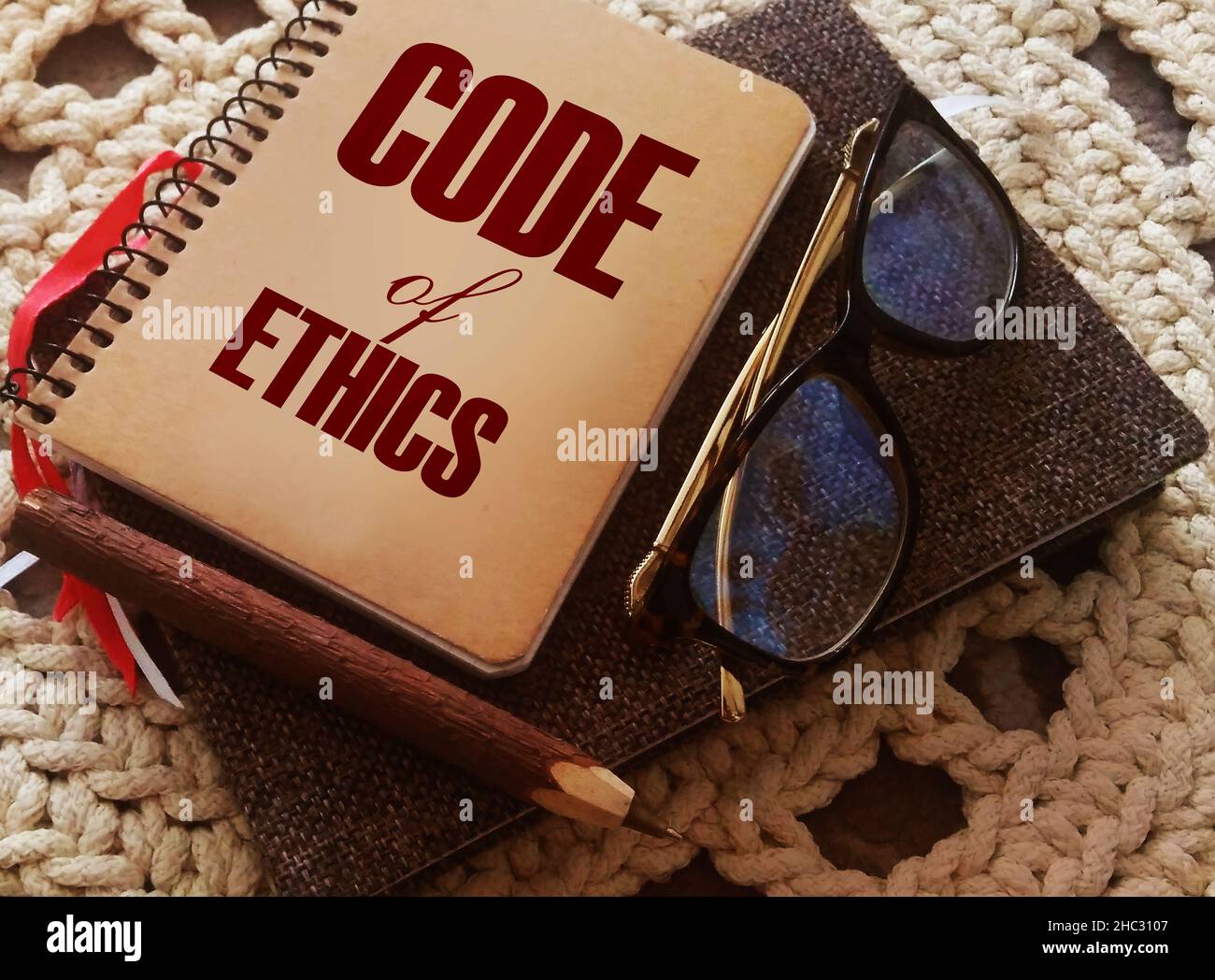 Code Of Ethics words on notebook, pen, glasses, crochet cloth. Business ...