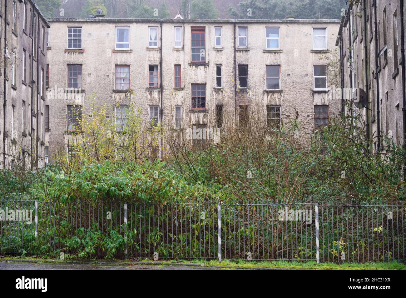 Derelict council house in poor housing estate slum with many social ...