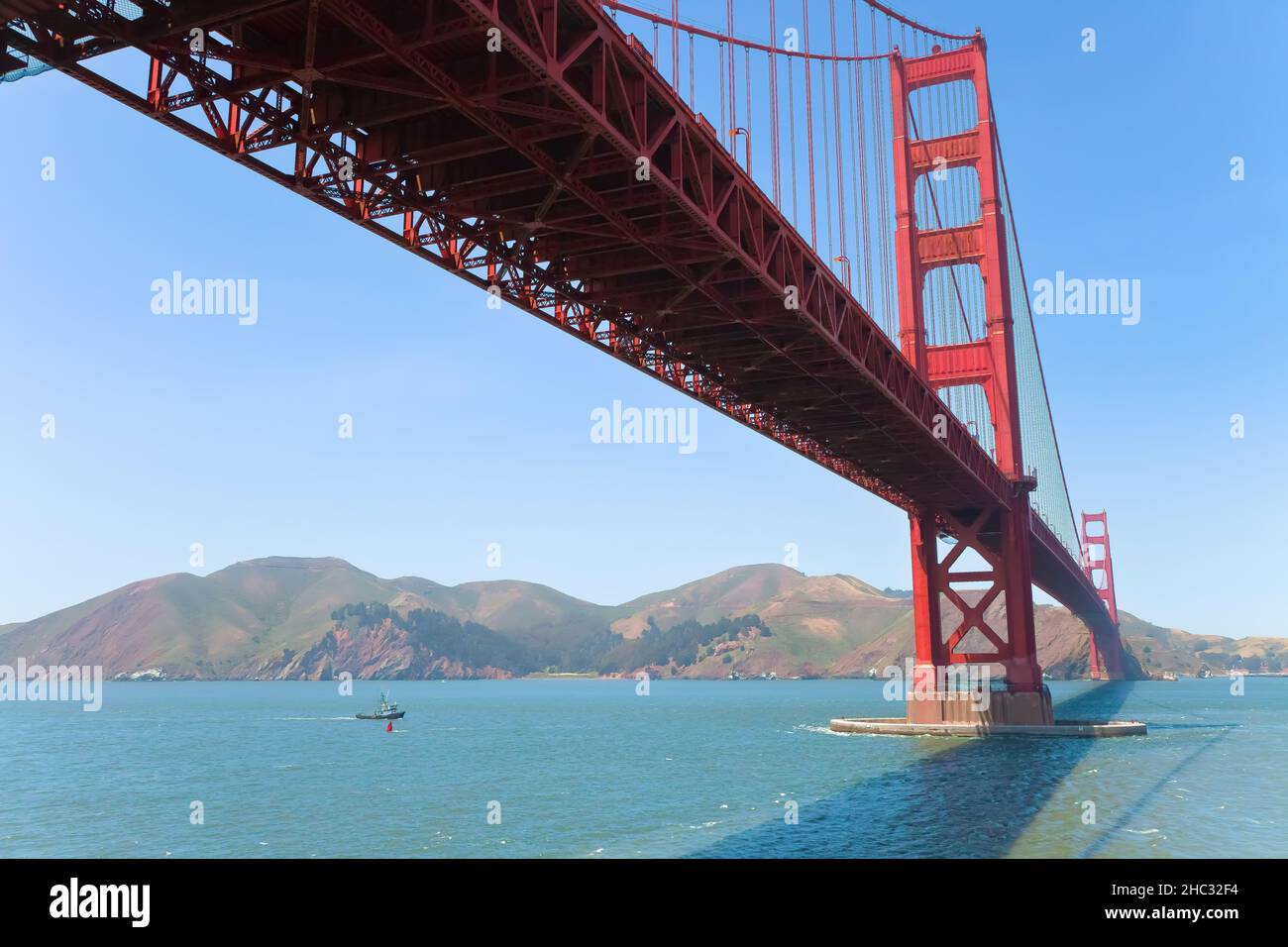 The image captures a low-angle view of the iconic Golden Gate Bridge in ...