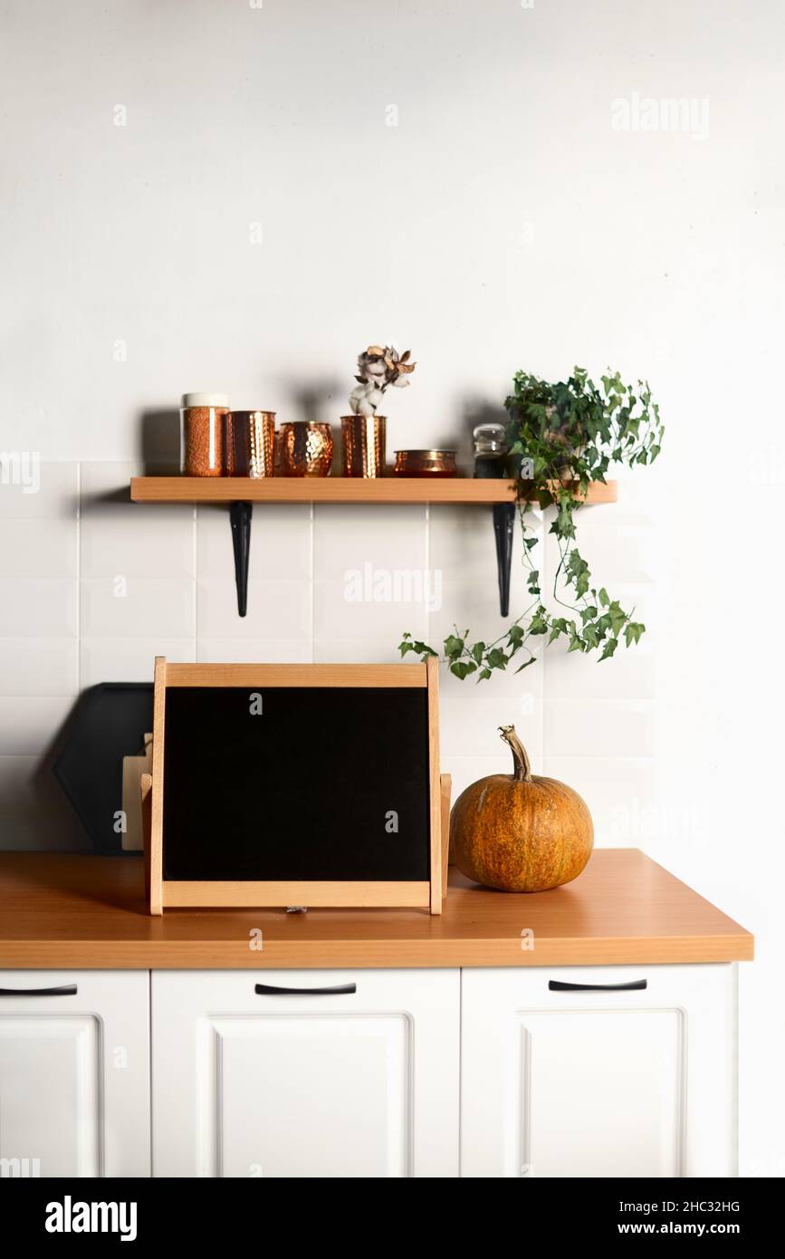 black letter board on kitchen countertop close-up. Part of the interior ...