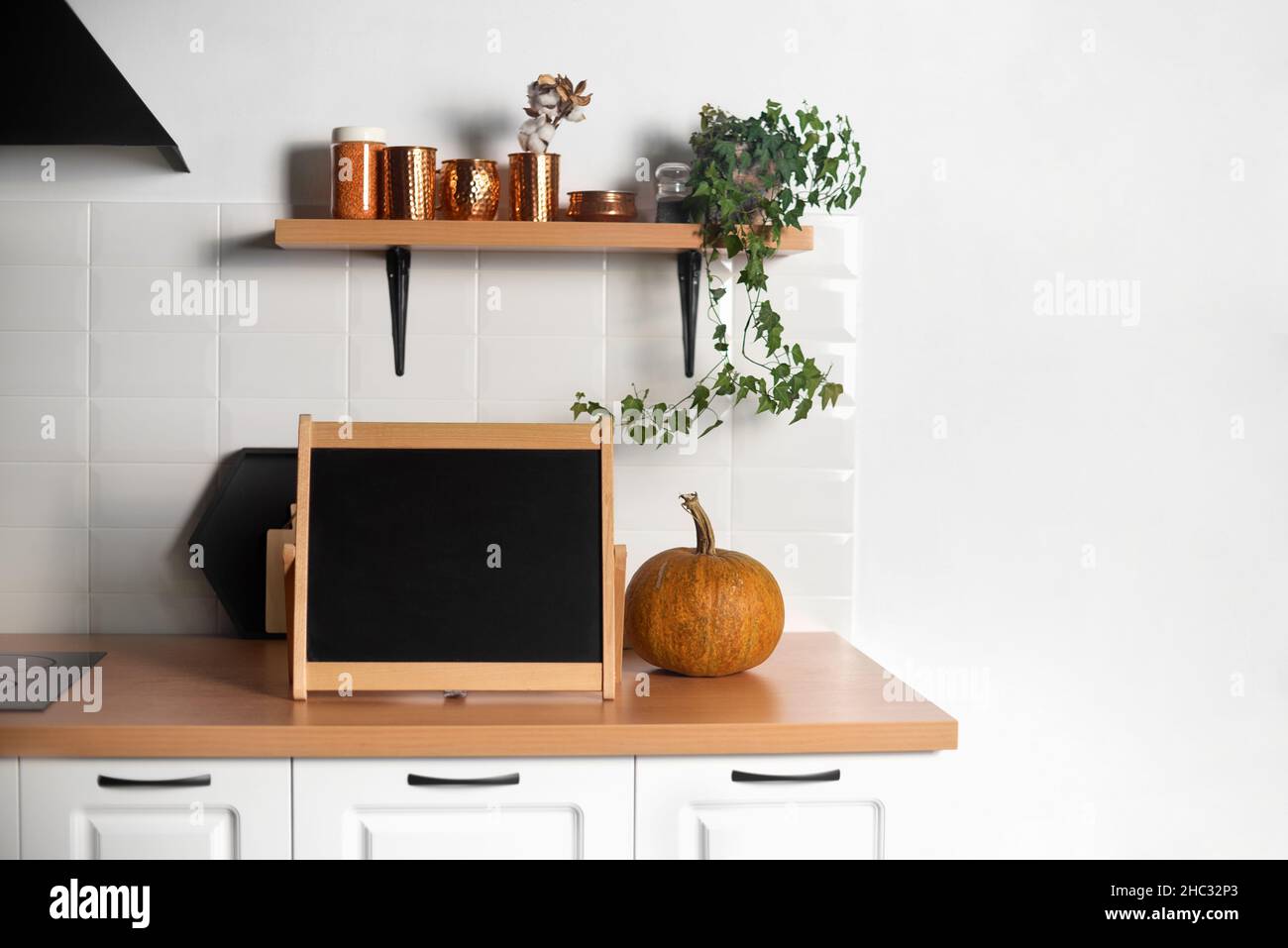 black letter board on kitchen countertop close-up. Part of the interior ...