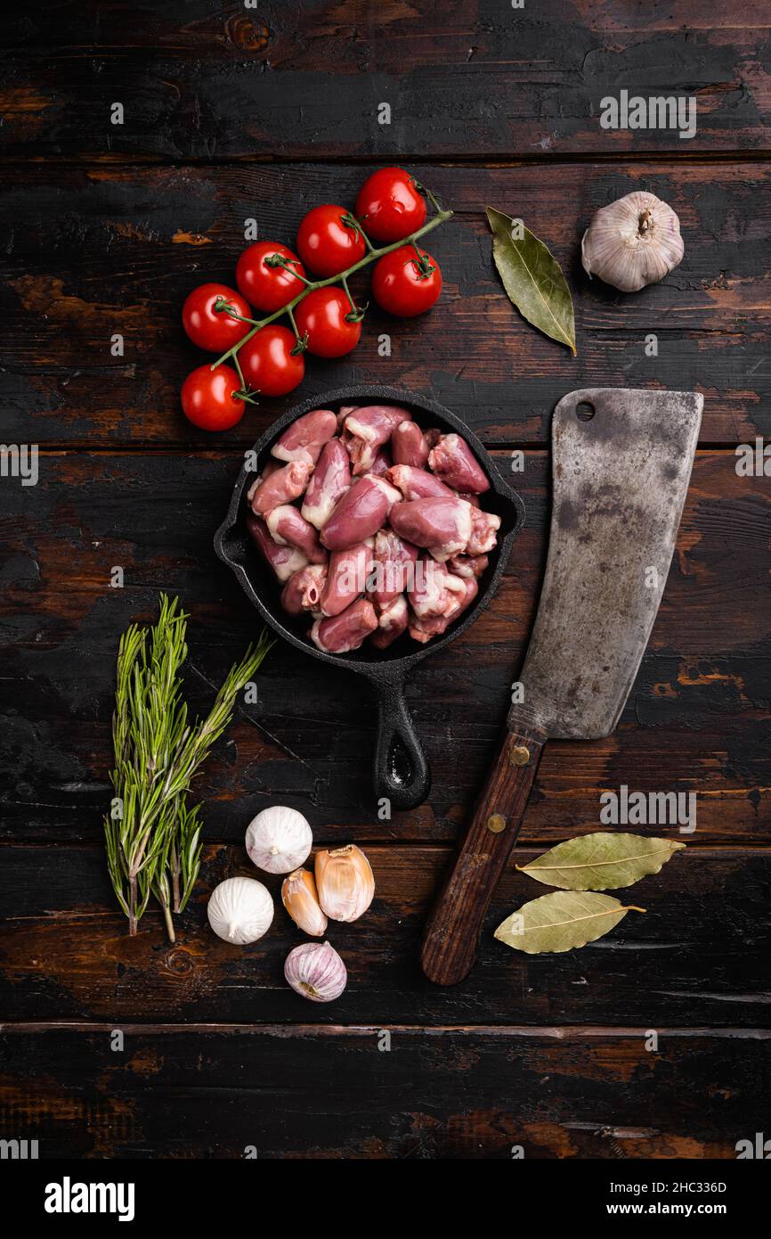 Raw uncooked chicken gizzards, chicken hearts set, on old dark wooden ...