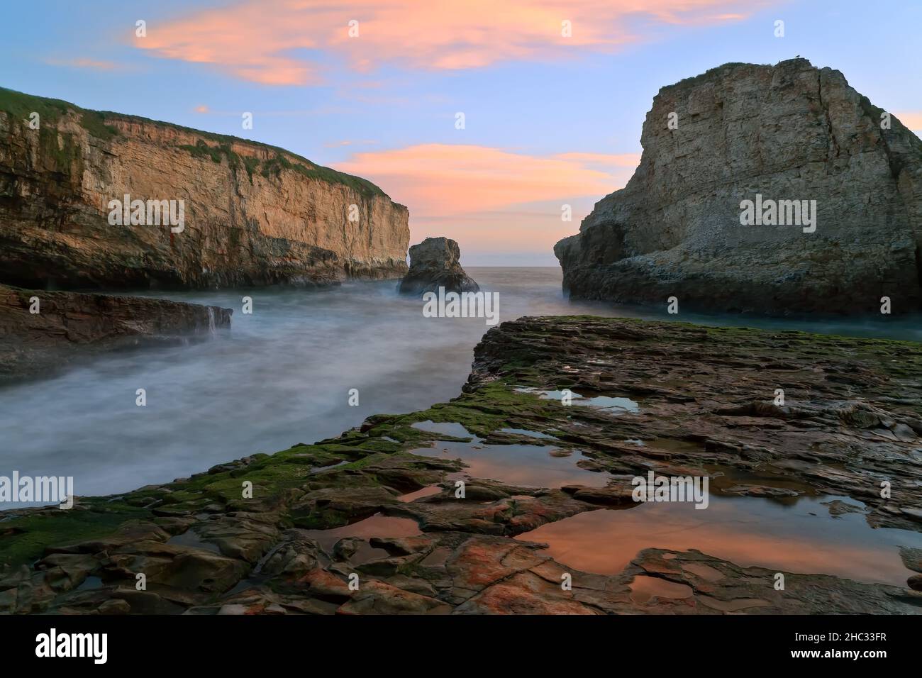 A breathtaking coastal scene with towering Shark Fin sea stack rising ...