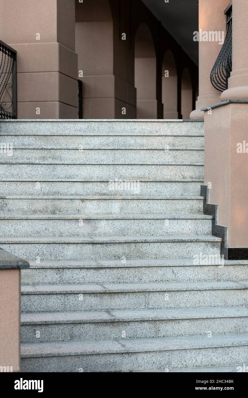 Gray concrete staircase leading to the arcade. Modern architecture ...