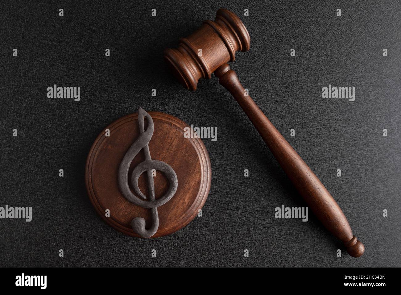 Music symbol treble clef and judge gavel on black background. Music ...