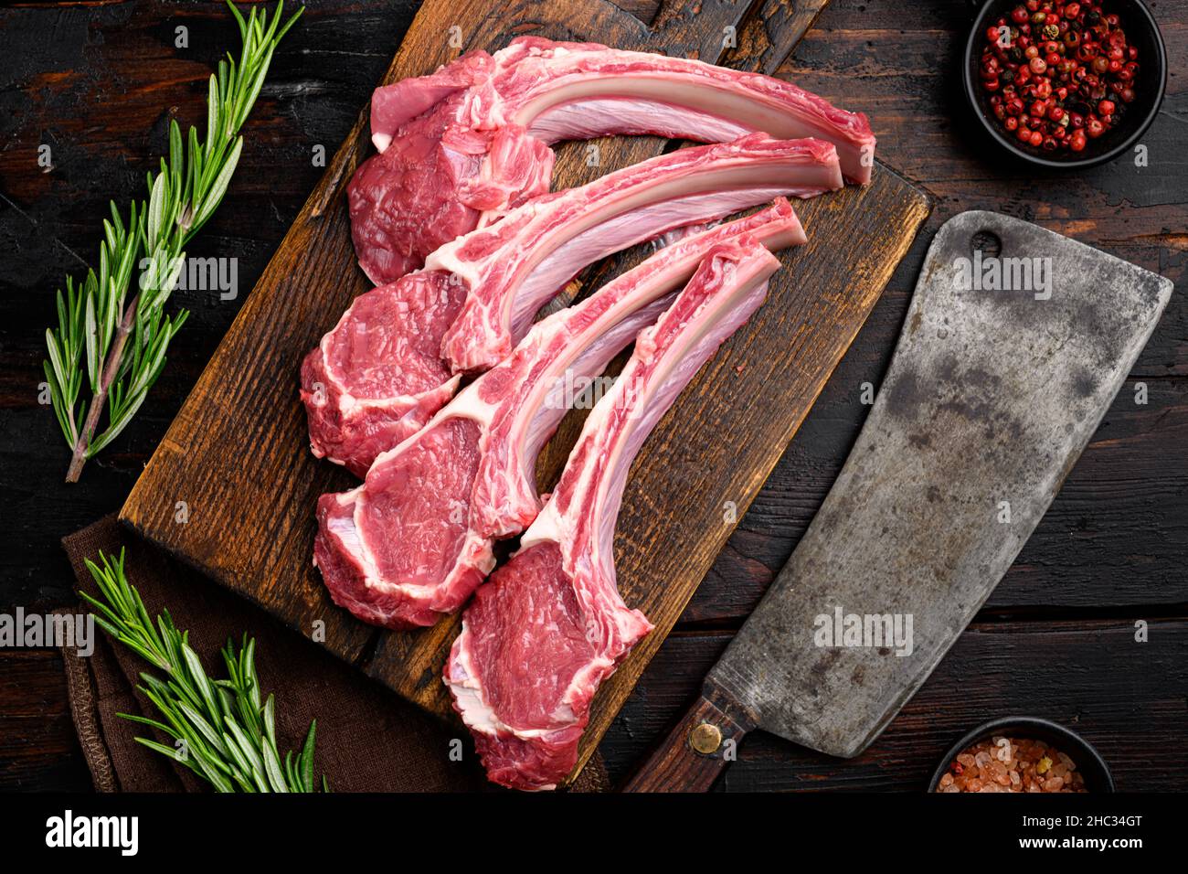 Raw Rack and rib chops of lamb, mutton set, on old dark wooden table ...
