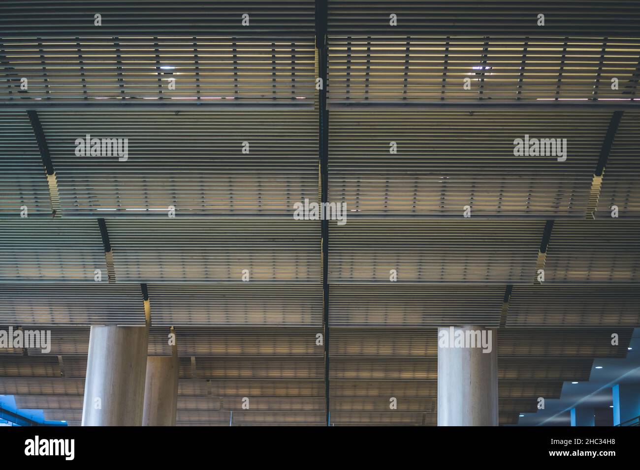 Modern ceiling with geometric lines in a row supported by architectural ...