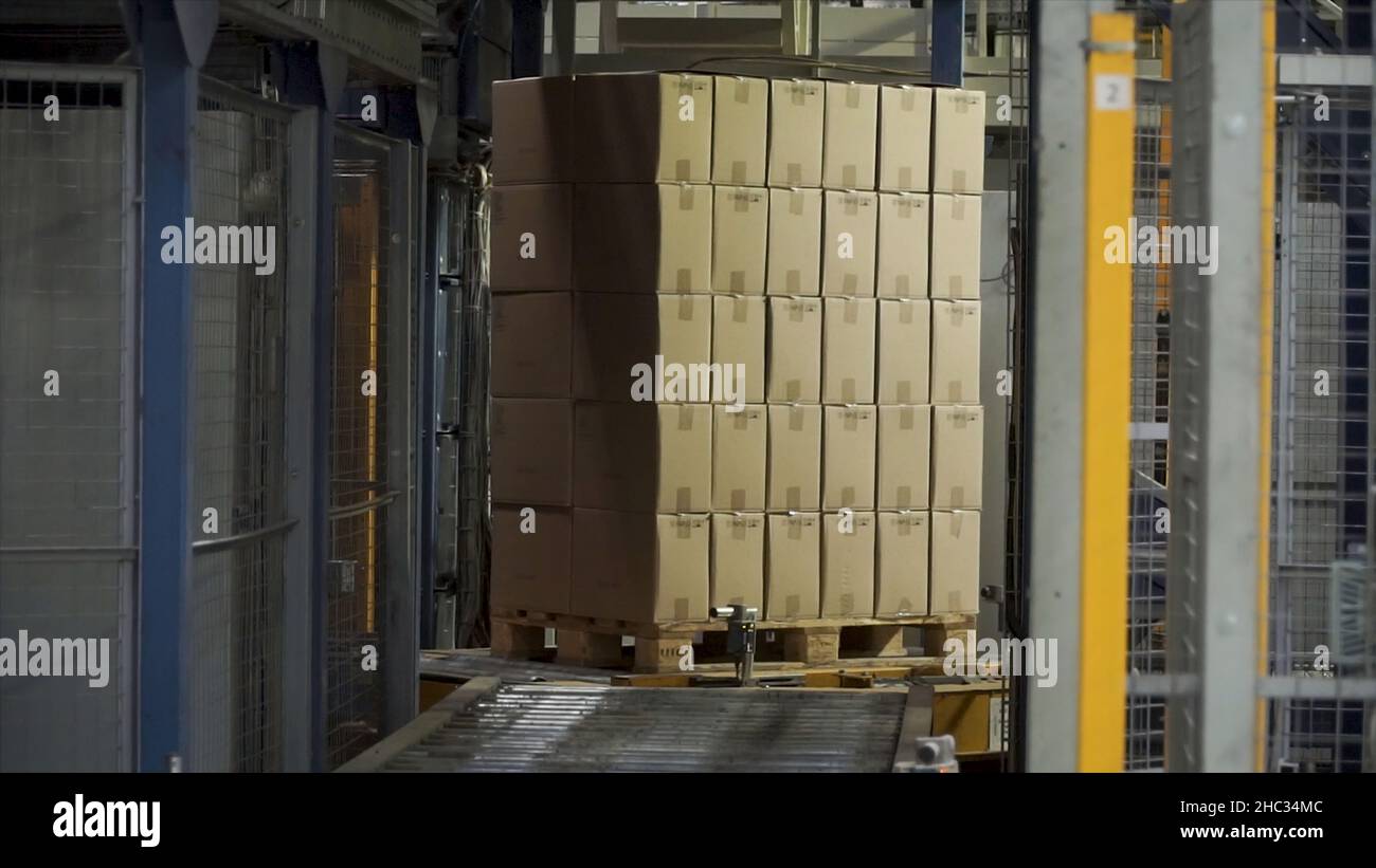 Shipping box in motion on conveyor belt, end of the line. Moving ...