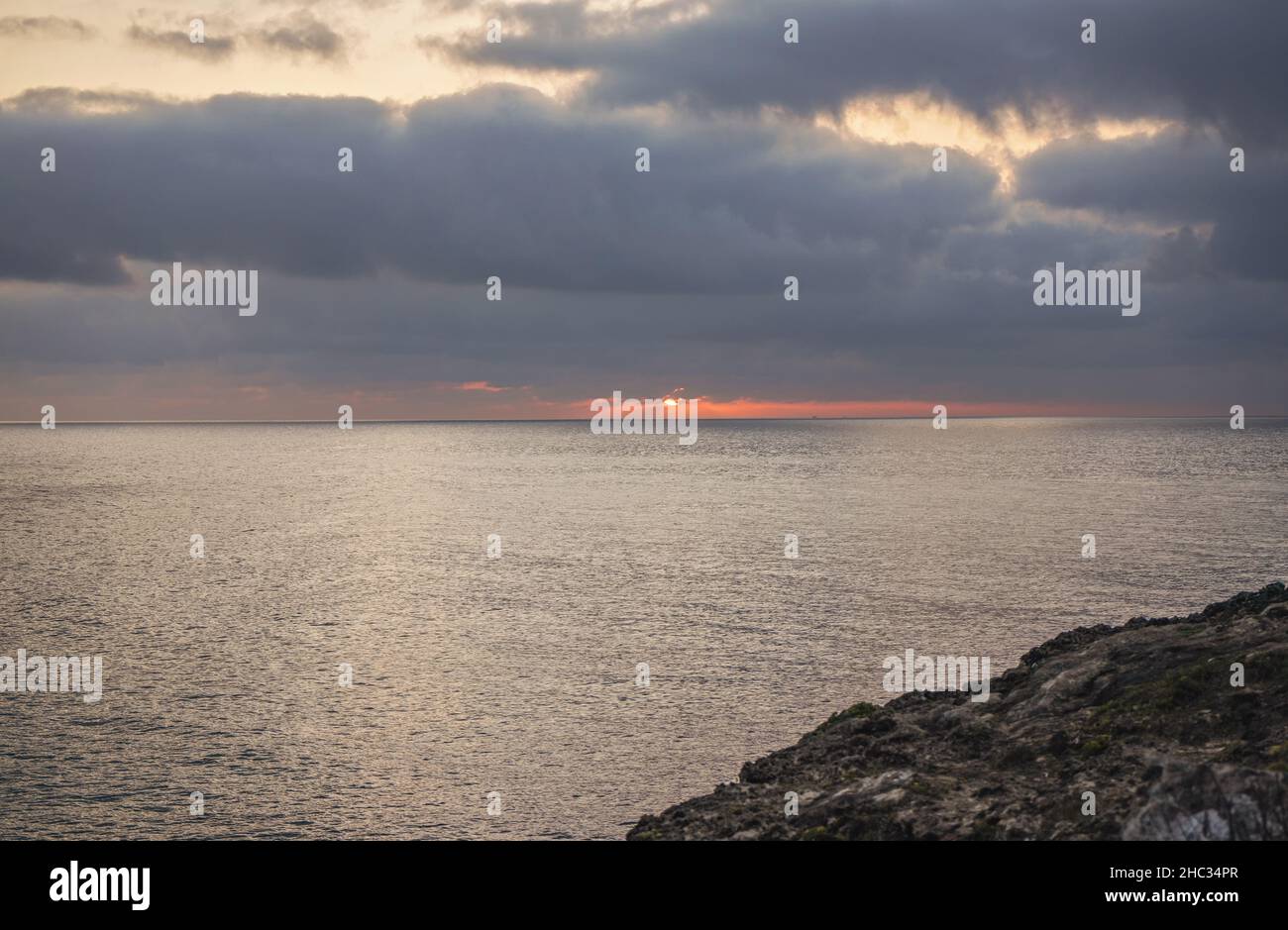Rising sun behind clouds hi-res stock photography and images - Alamy