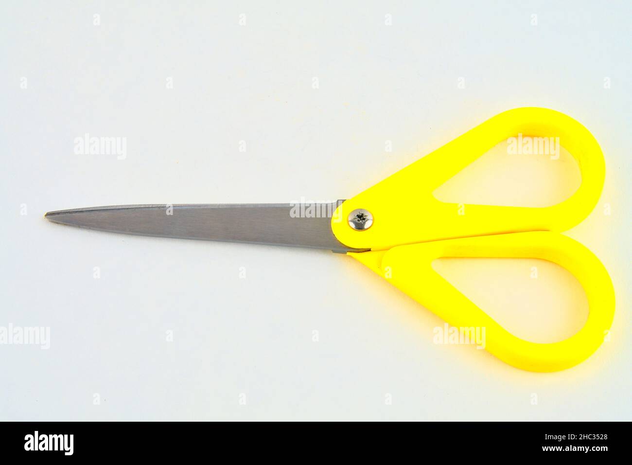 Yellow scissors isolated on a white background. Top view Stock Photo ...