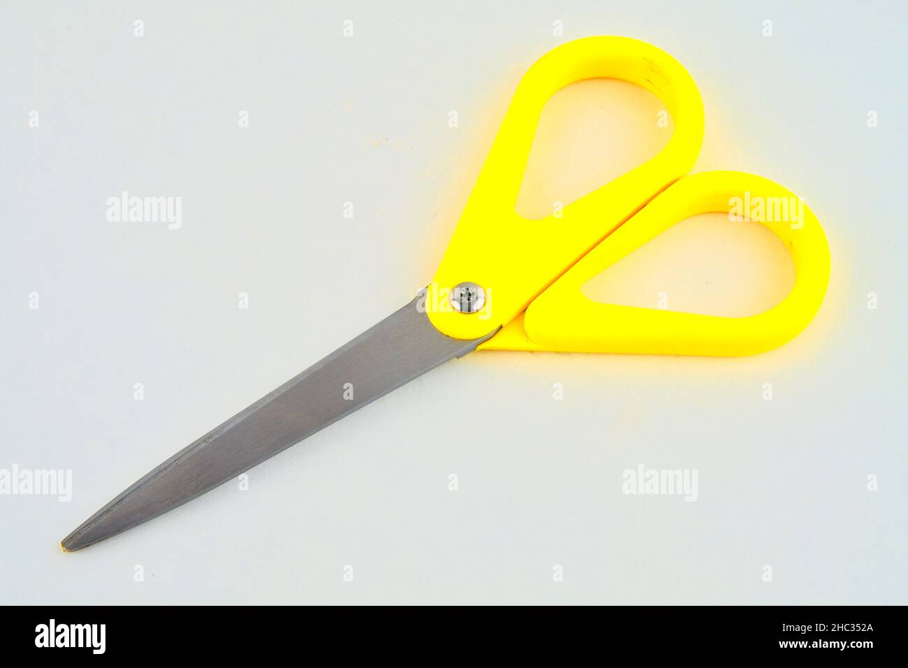 Yellow scissors isolated on a white background. Top view Stock Photo ...