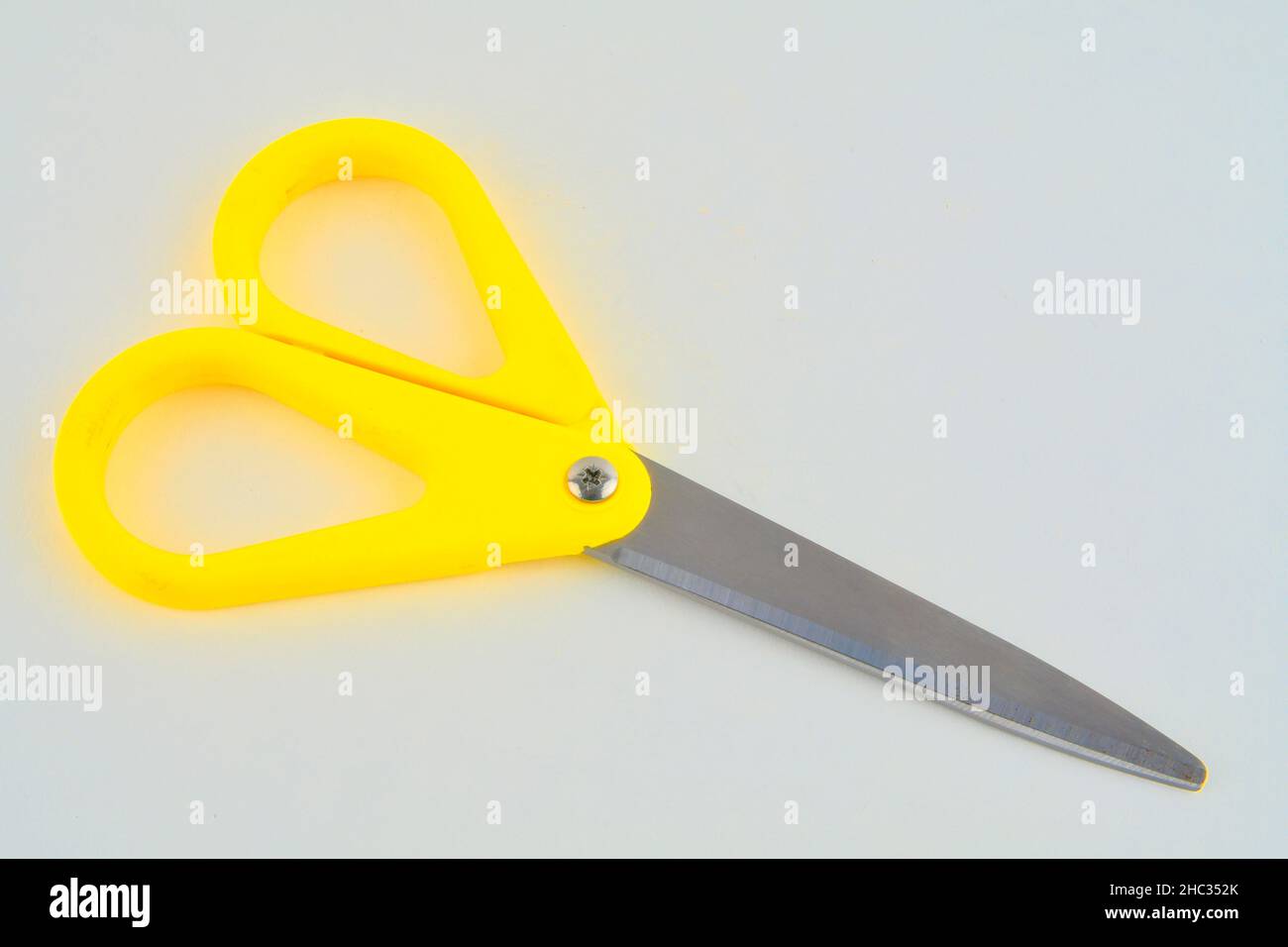 Yellow scissors isolated on a white background. Top view Stock Photo ...