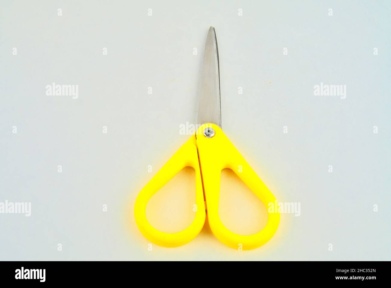Yellow scissors isolated on a white background. Flat design. Top view ...