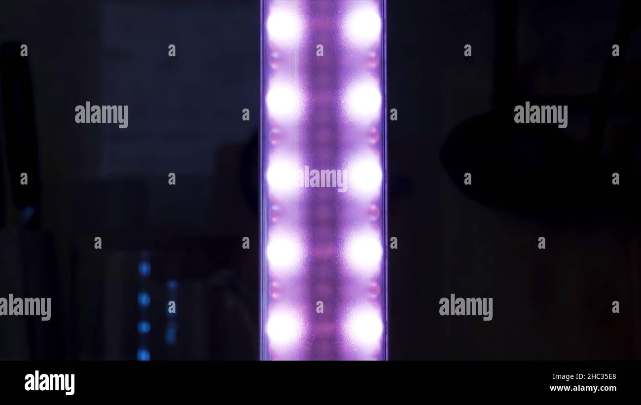 Purple color led strip light shining in the dark room. Close up of ...