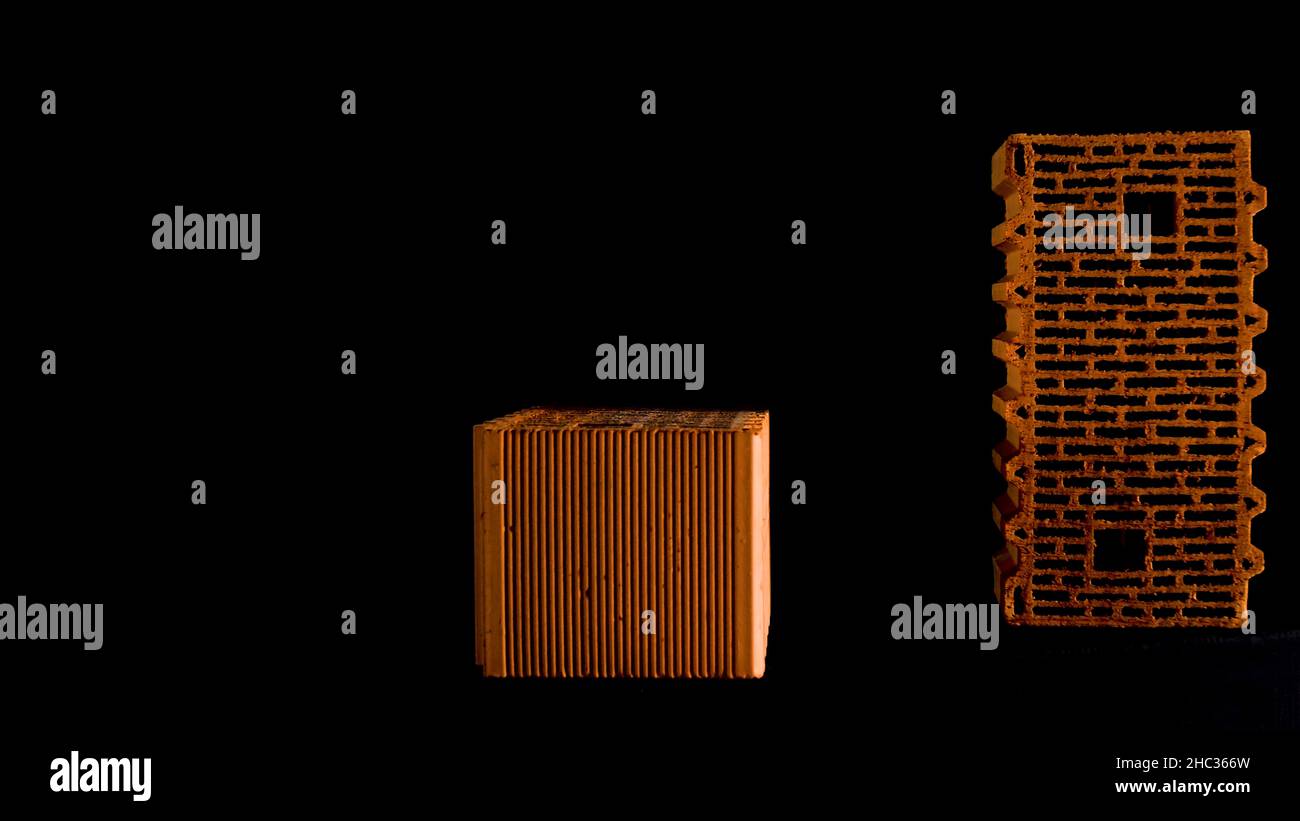 Close up of two orange bricks isolated on black background. Building ...